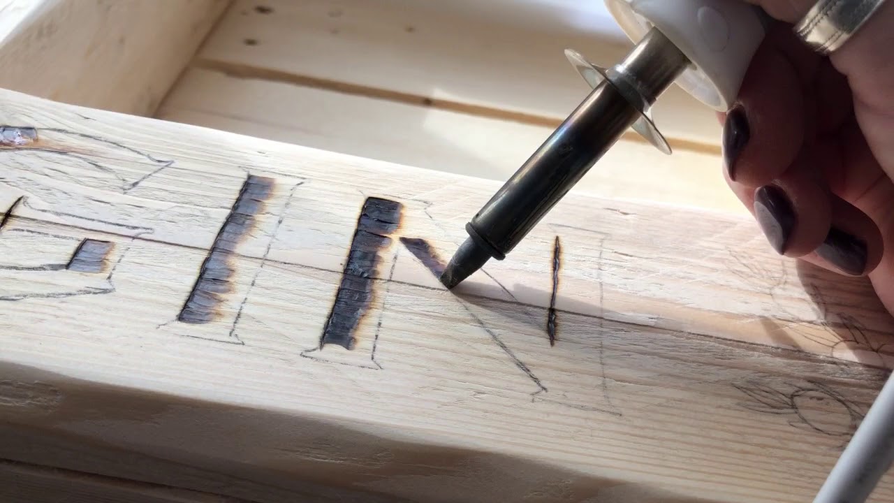 Close up of burning letters on to pallet wood using pyrography - YouTube