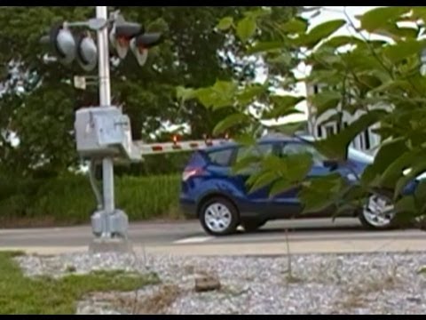 Train crossing gate hits car - YouTube