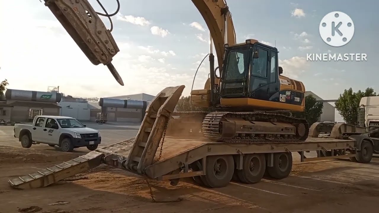 CAT Breaker Loading and Unloading from Lowbed Trailer - YouTube