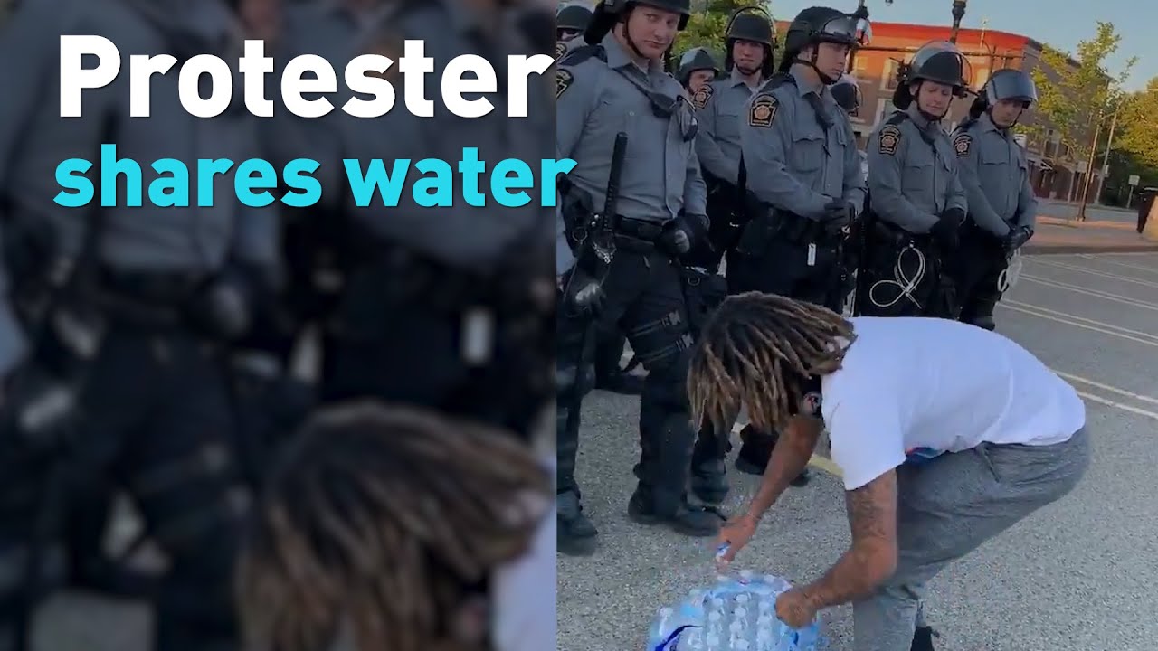 See protesters donating water to police and thanking them - YouTube