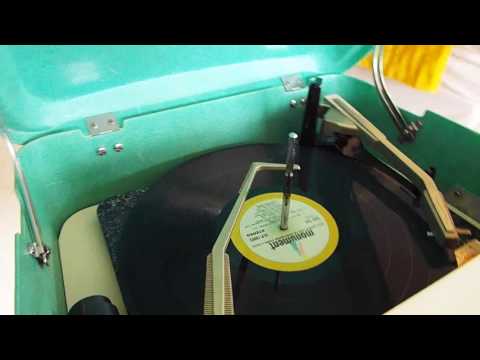 Silvertone fiberglass case, AM phono playing a 33.3 RPM LP record.