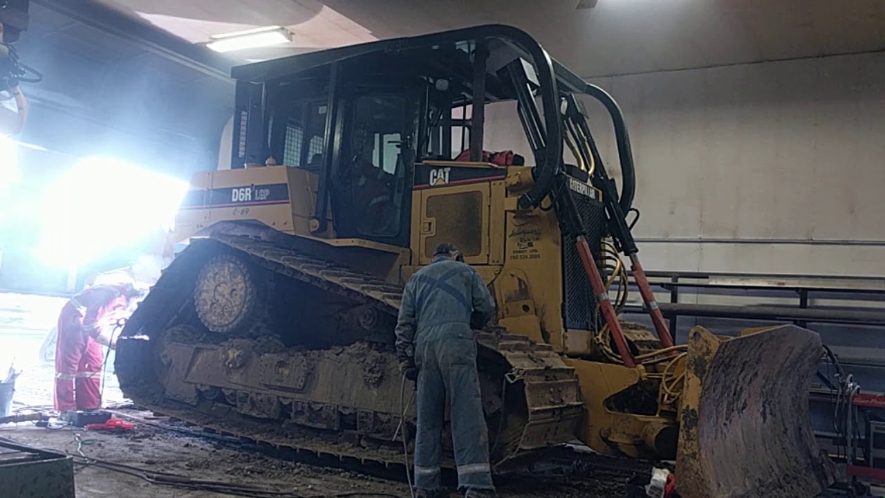 Welding ice lugs on cat tracks - YouTube