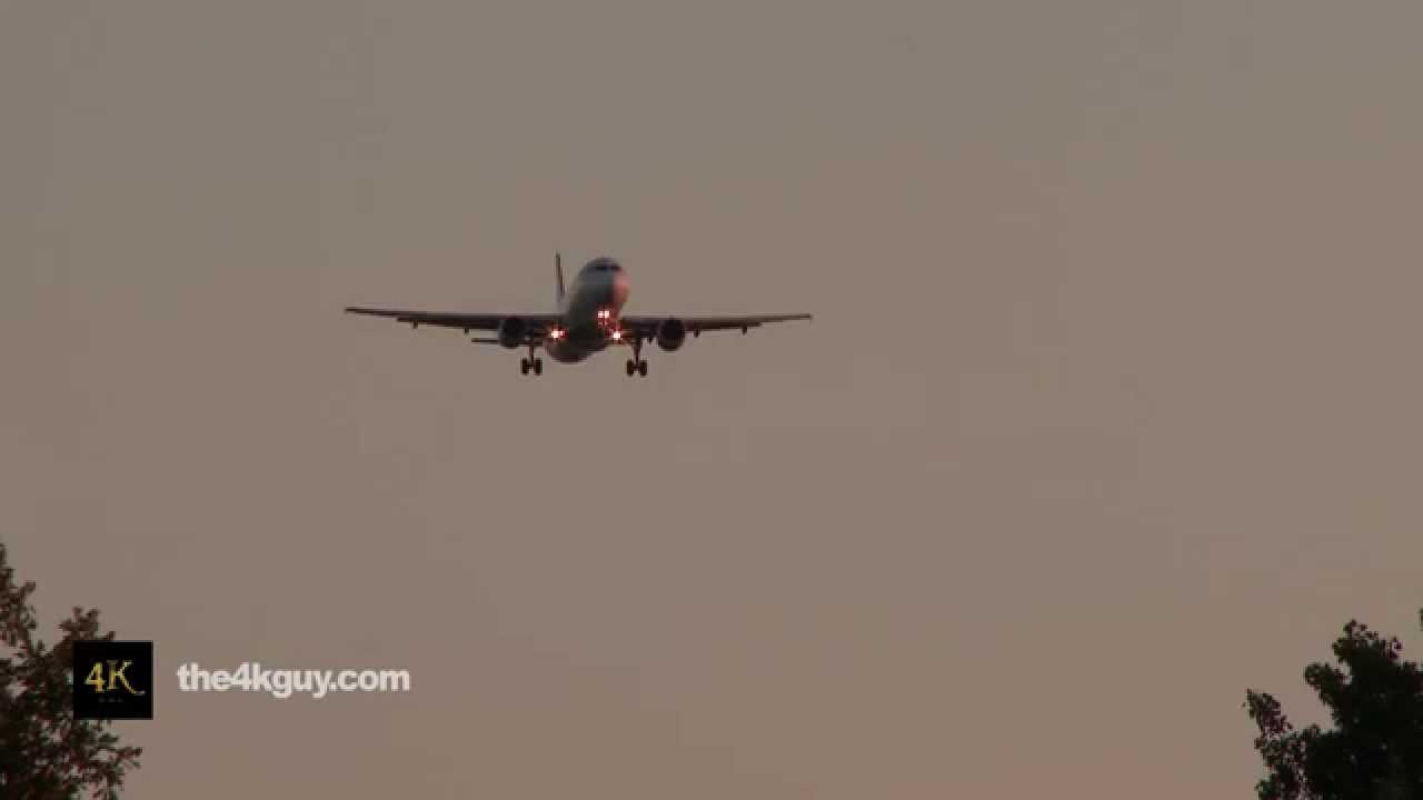 4K UHD - Airplane flying towards camera moving sideways with light ...