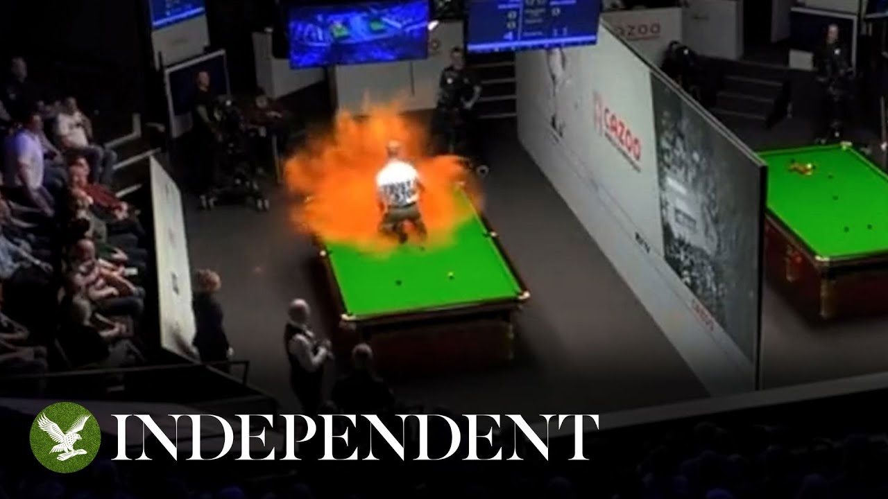 Just Stop Oil protester covers snooker table in orange powder during ...