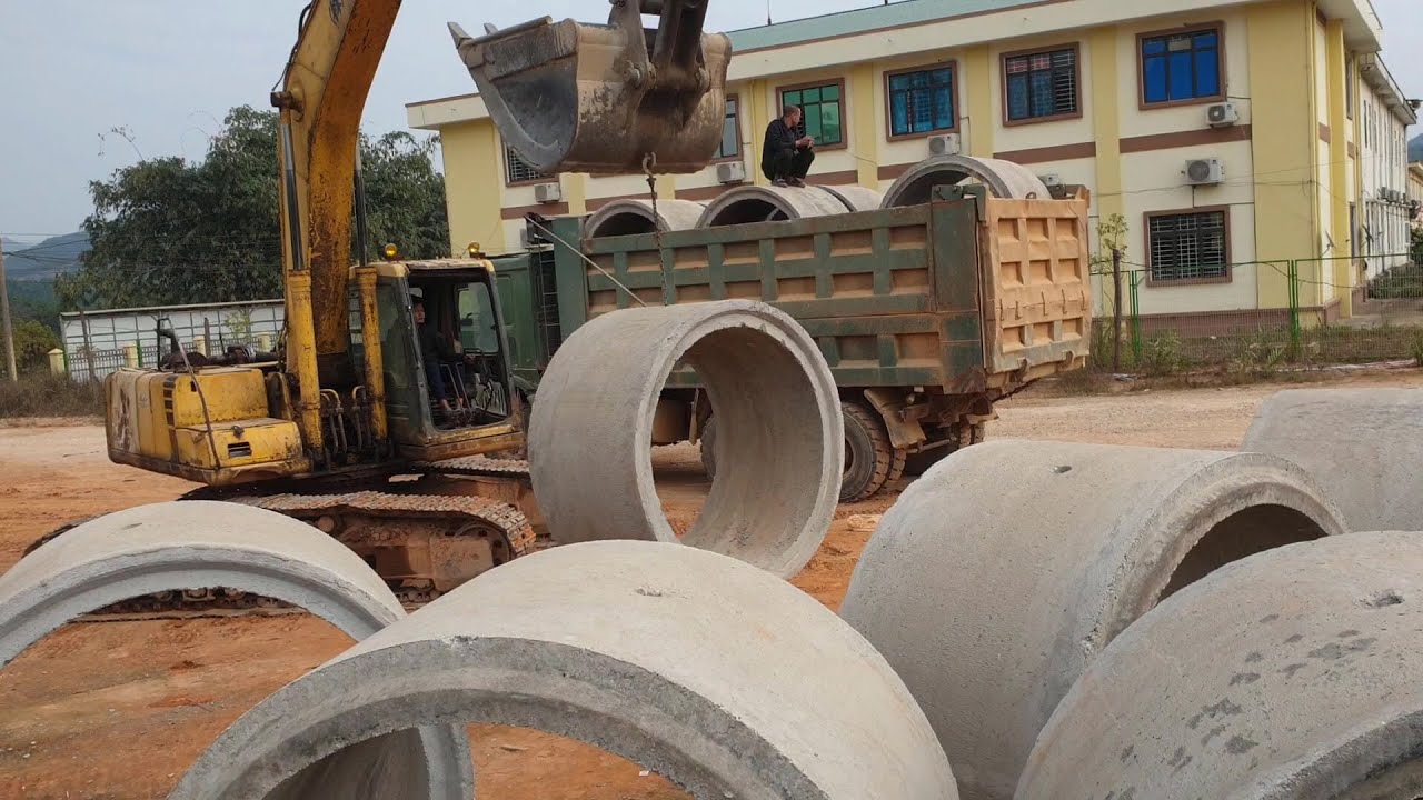 Excavator Laying Concrete Drain Pipes ️ Moving Drainage With Truck ...