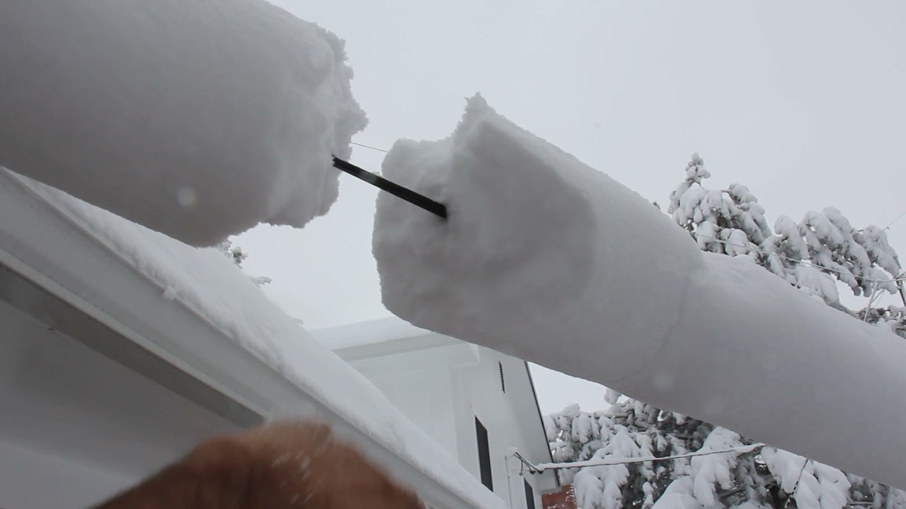 Snow "tube" around a telephone wire going into a house - YouTube