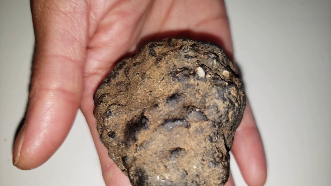 Is it a meteorite or slag or what? Any rockhounds out there know? - YouTube