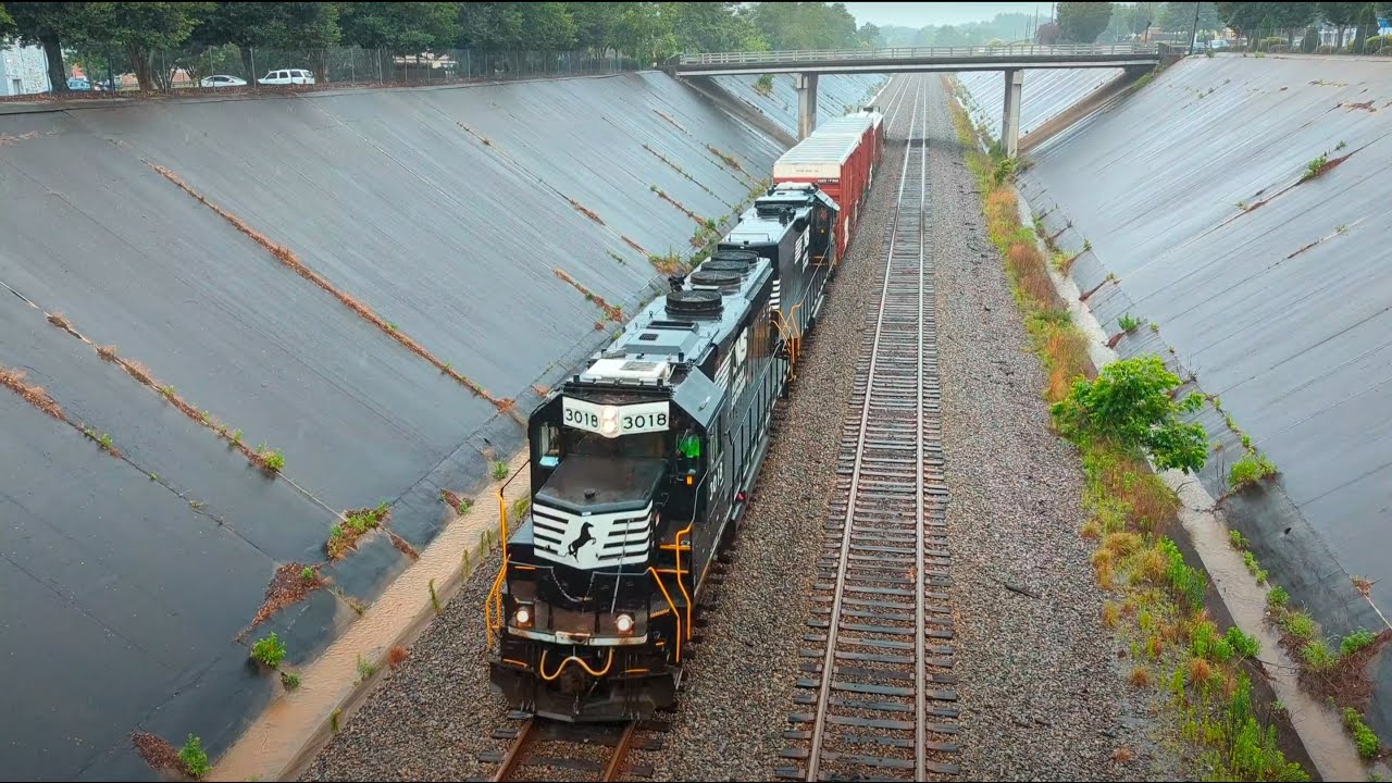 Small NS freight train (with a slug) pulls through the rain in the ...