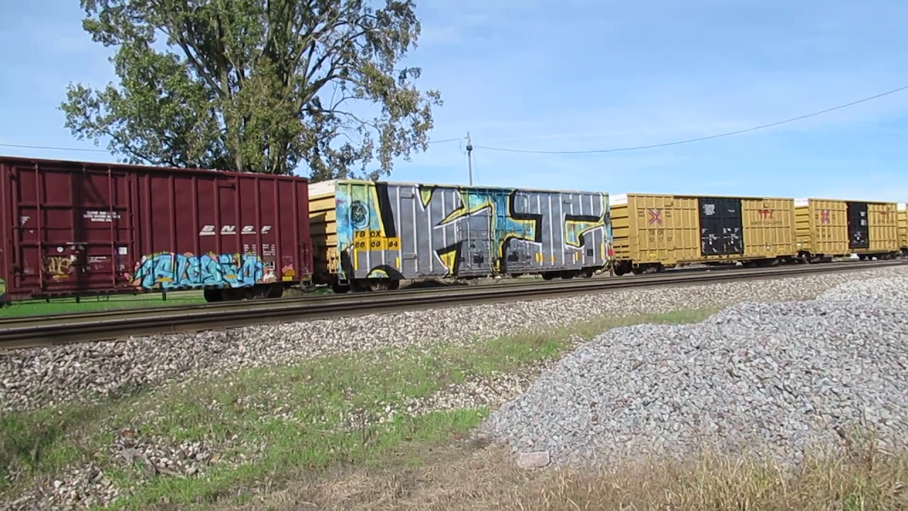 CN SD60 5473 takes a string of graffiti covered box cars out of the siding at Pavilion, MI ...