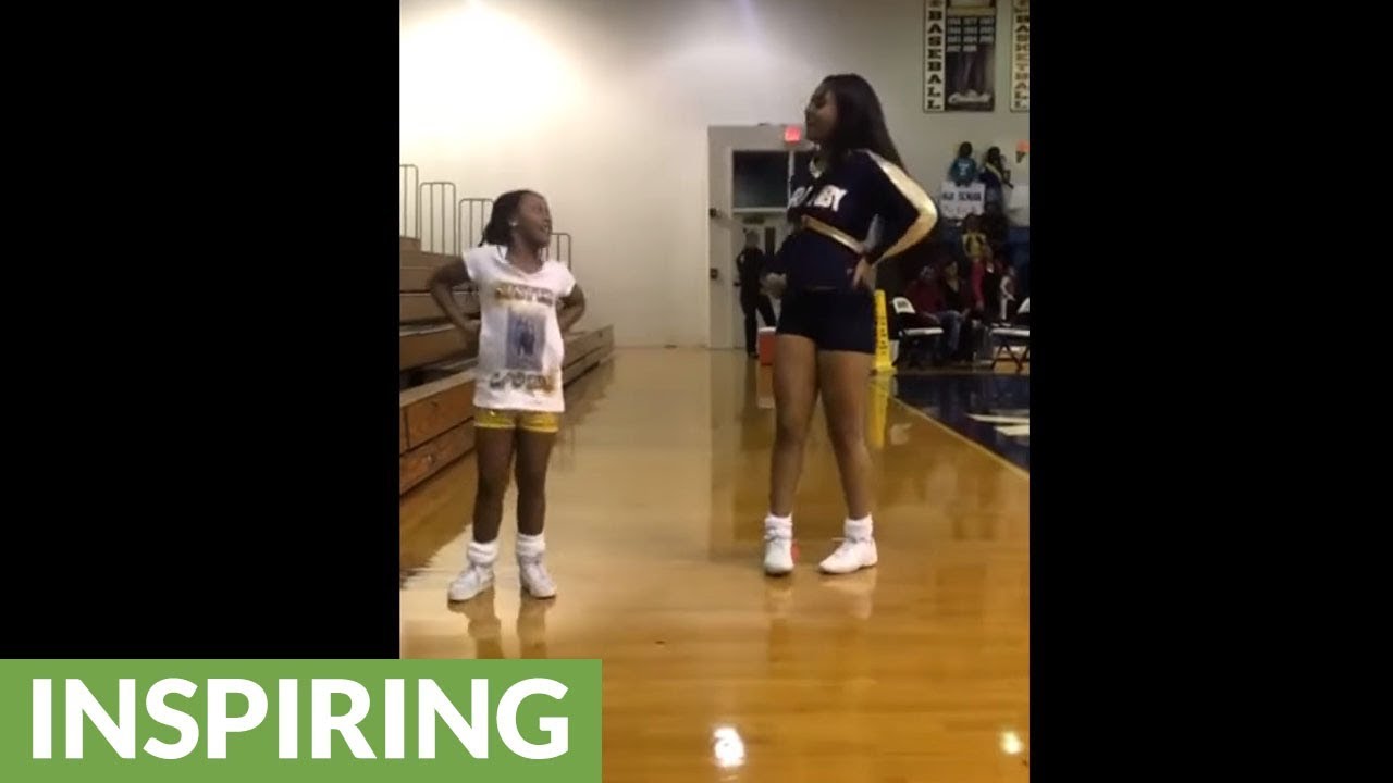 Little girl joins in on big sister's cheer solo - YouTube