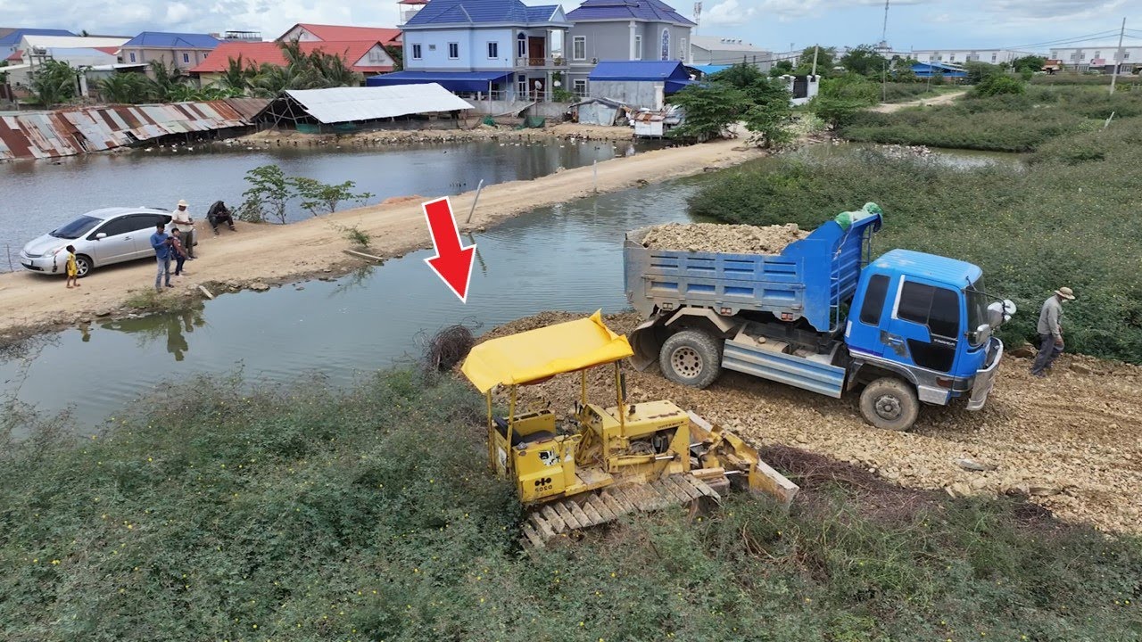Amazing action Strong Bulldozer Water and Stone are Being Forced Into ...