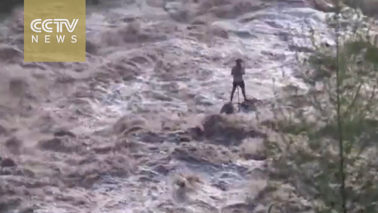 Shocking footage: Man stranded in middle of turbulent flood - YouTube