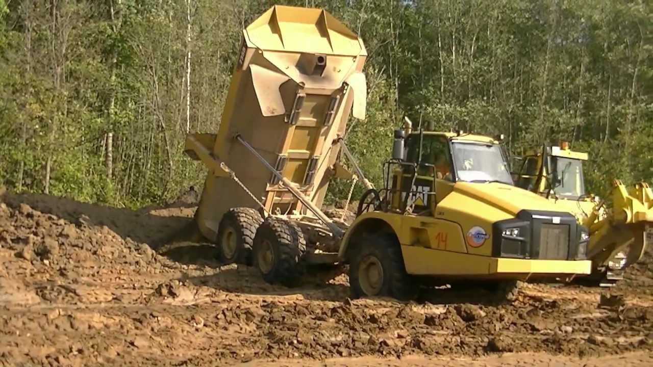 Cat 735B ADT`s unloading - YouTube