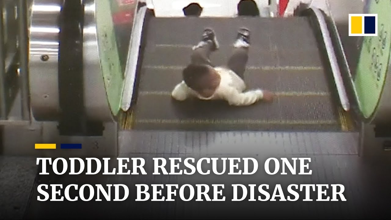 Toddler rescued from escalator one second before disaster - YouTube