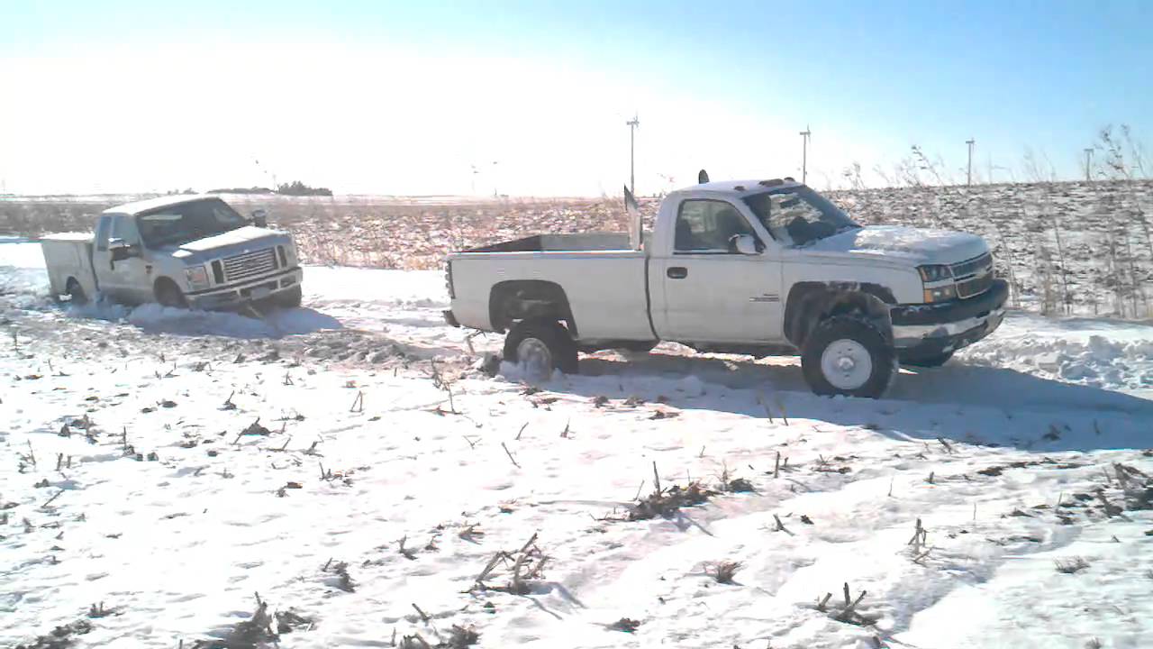 Getting a stuck truck out of the mud and snow. - YouTube