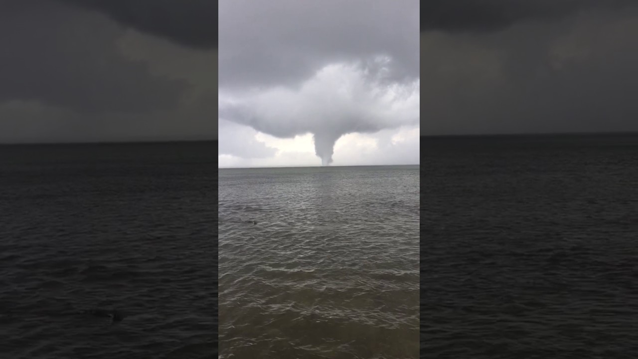 Water spout with a dolphin destin Florida - YouTube