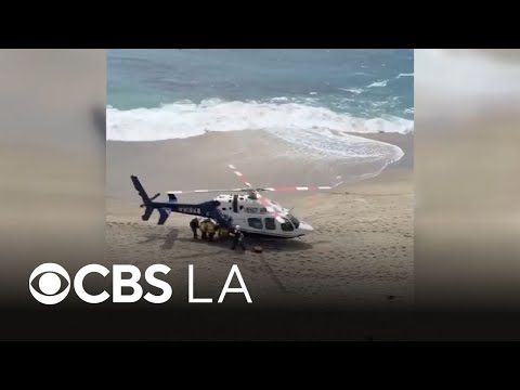 Strong waves sweep woman into the ocean at Aliso Beach