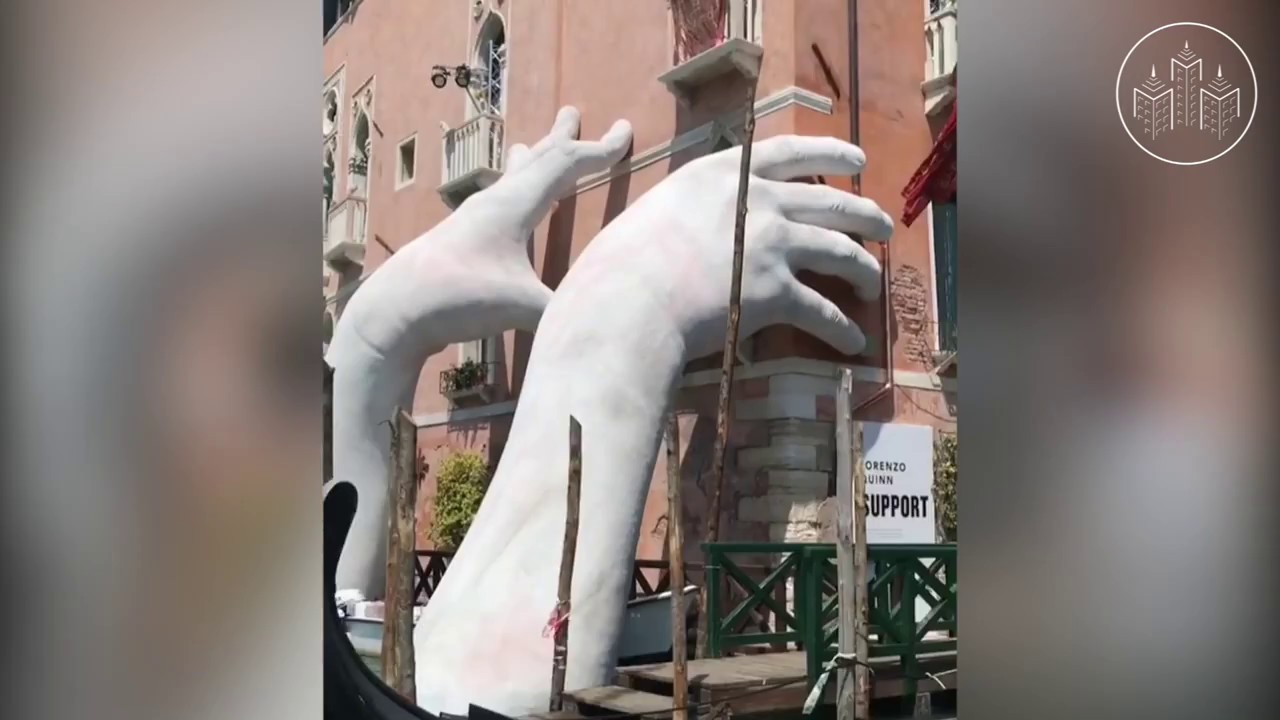 Two Giant Hand Sculptures Emerge in Venice - YouTube