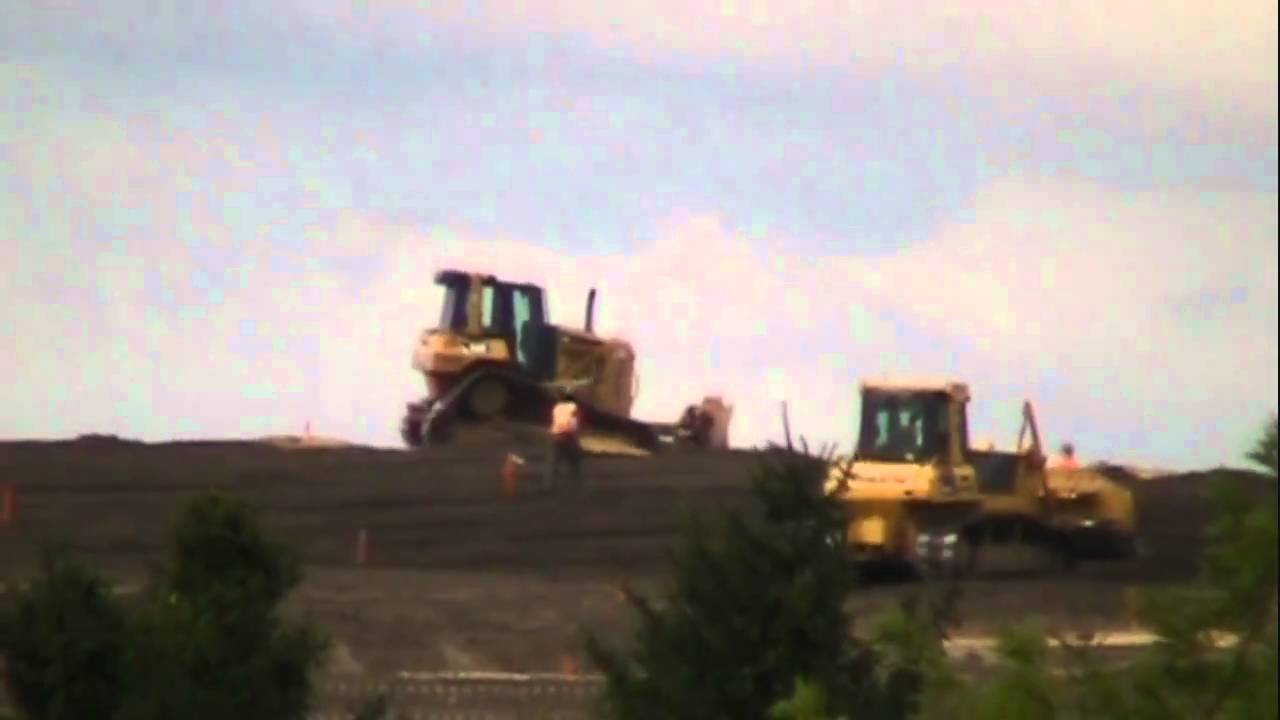 Komatsu and Cat dozers working on a landfill - YouTube