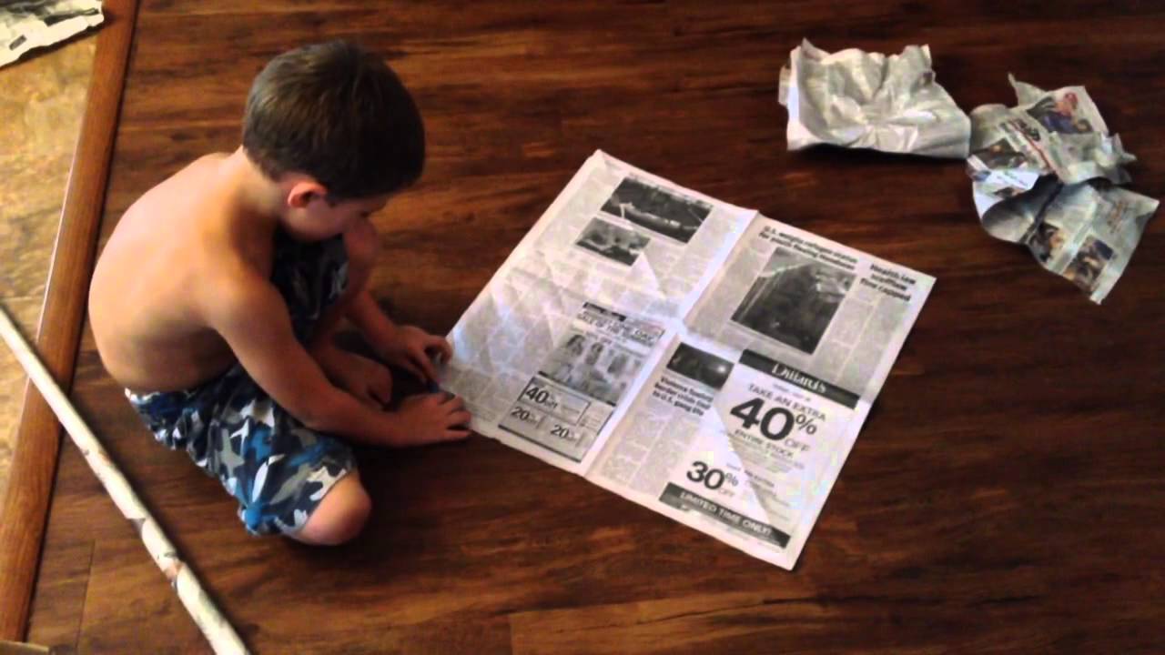 How to help your child roll newspaper - YouTube