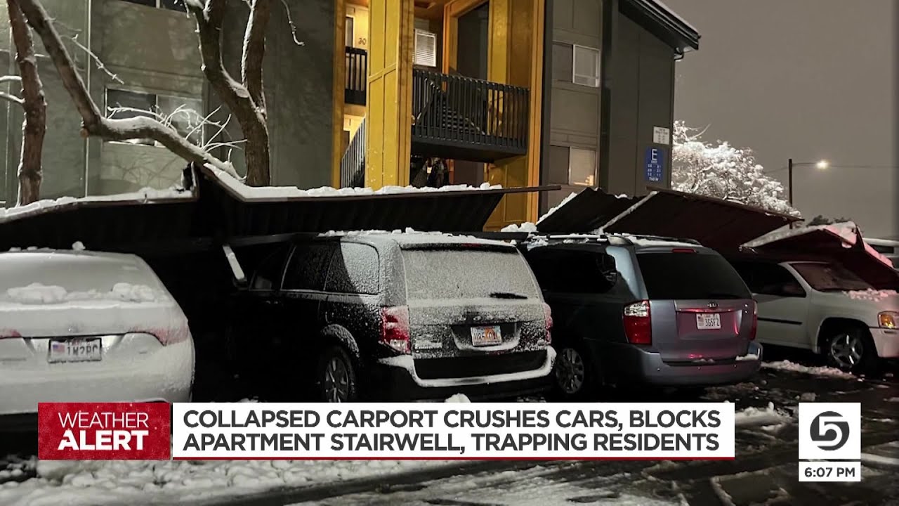 Collapsed carport crushes cars and blocks apartment stairwell, trapping ...