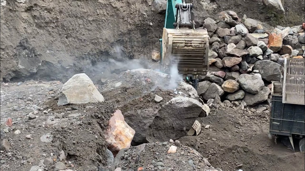 Excavator heavy equipment works to dig and load sand into trucks - YouTube