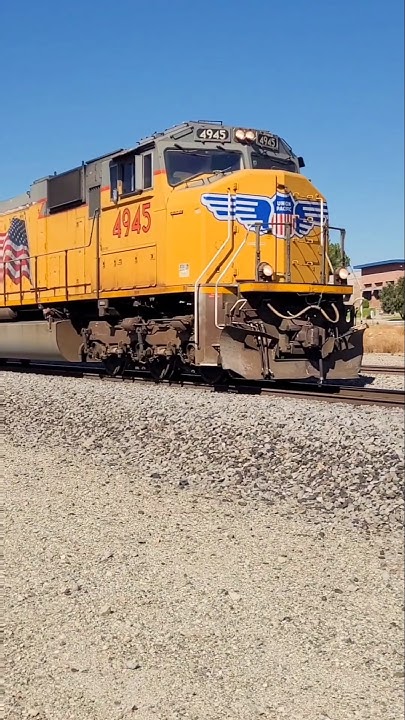 UP 4945 leads a single loaded centerbeam rail car down the grade at San Gorgonio Pass. #trains ...