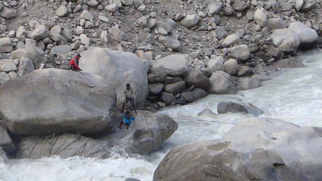 Porter crossing river using Tyrolean traverse - YouTube