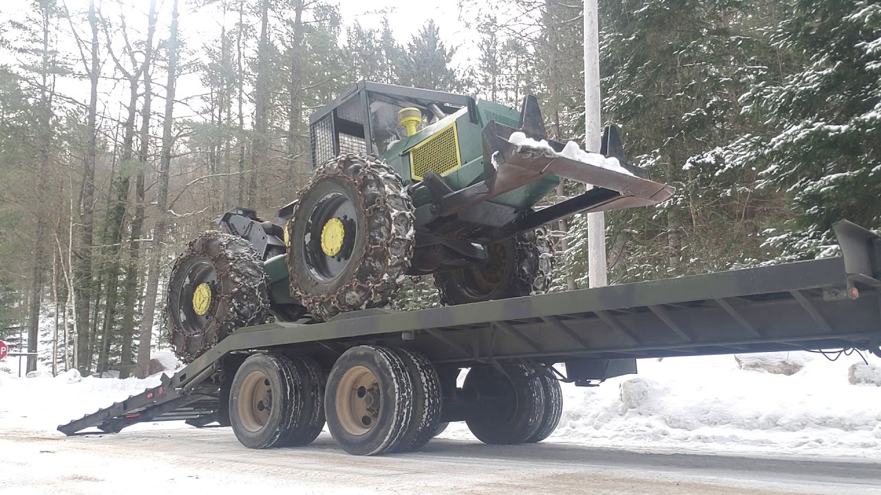 Loading the Tree Farmer C5D skidder onto the M322 trailer - YouTube