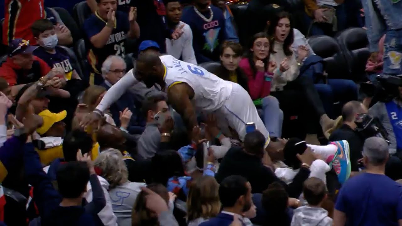 LeBron James fearlessly dives for the ball into the crowd without ...