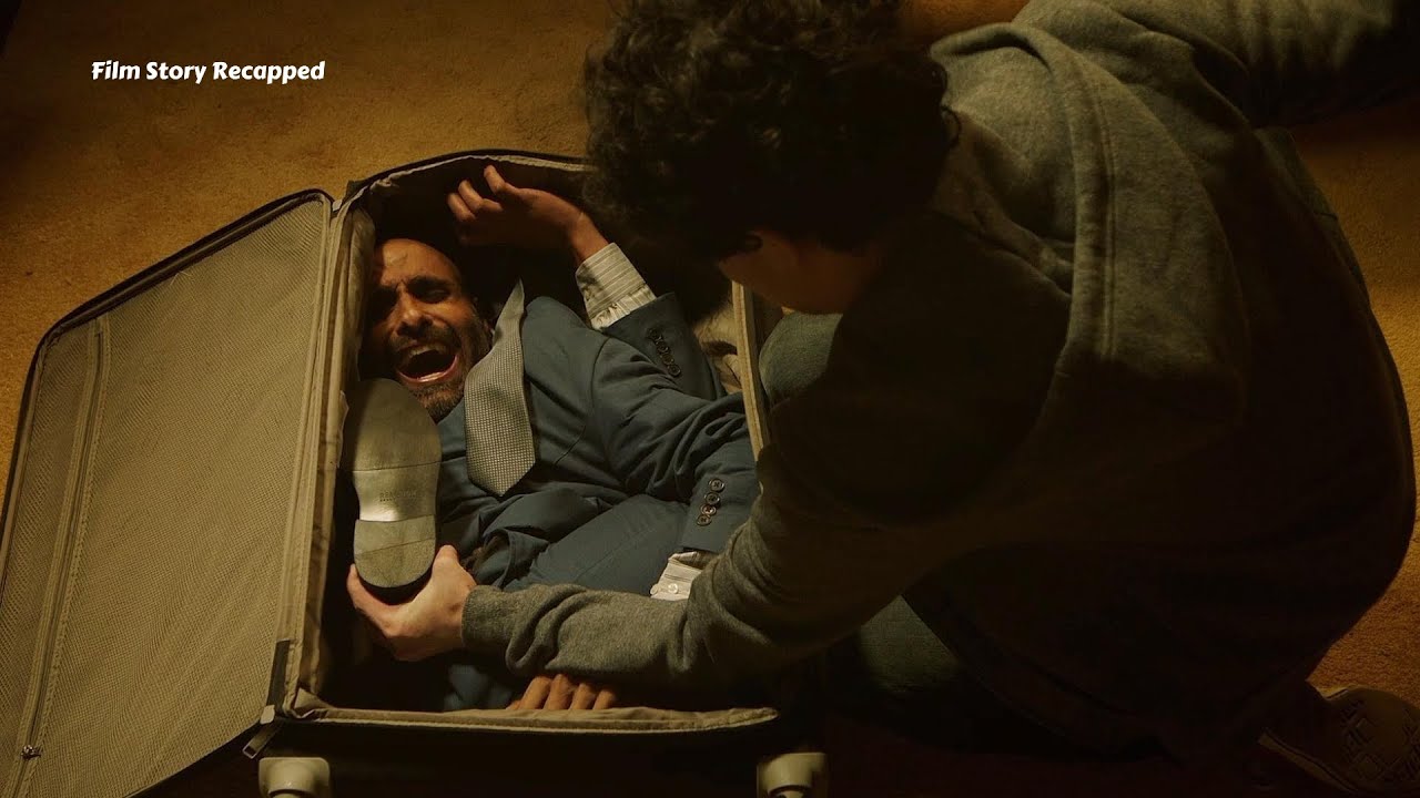 A man trapped in a suitcase spits out gold coins whenever he is in pain ...