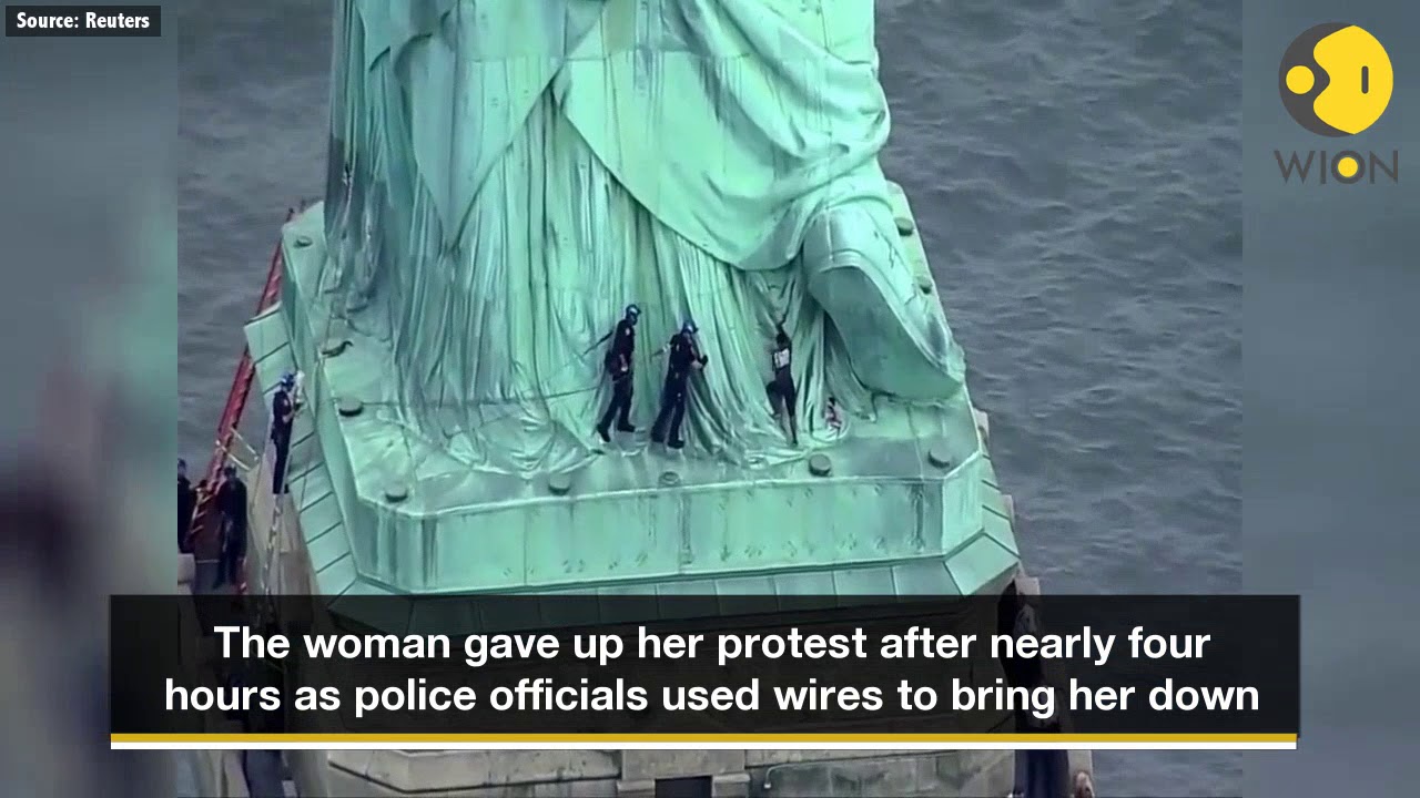 Woman tries to scale Statue of Liberty to protest against Trump's ...