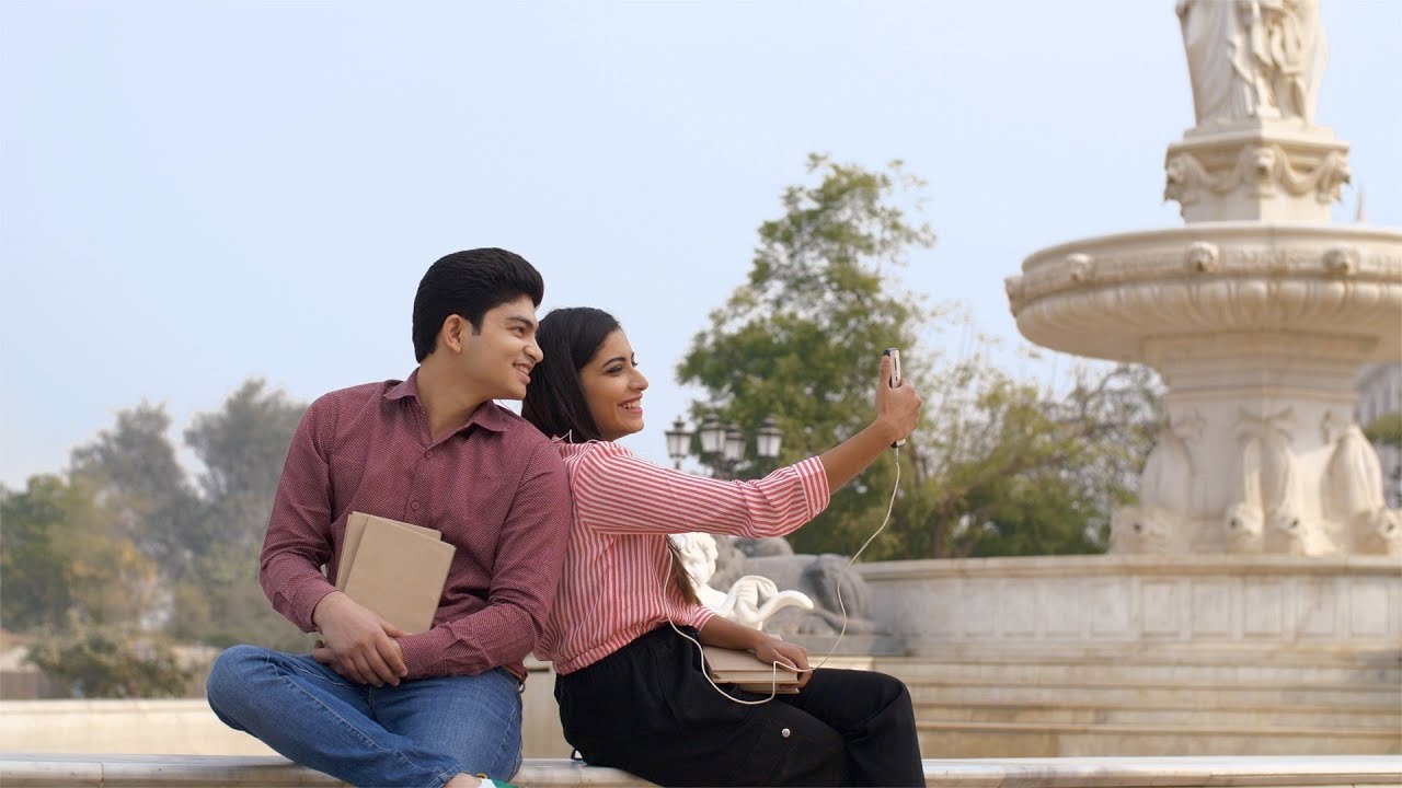 Cheerful Indian couple doing video call together using a smart ...