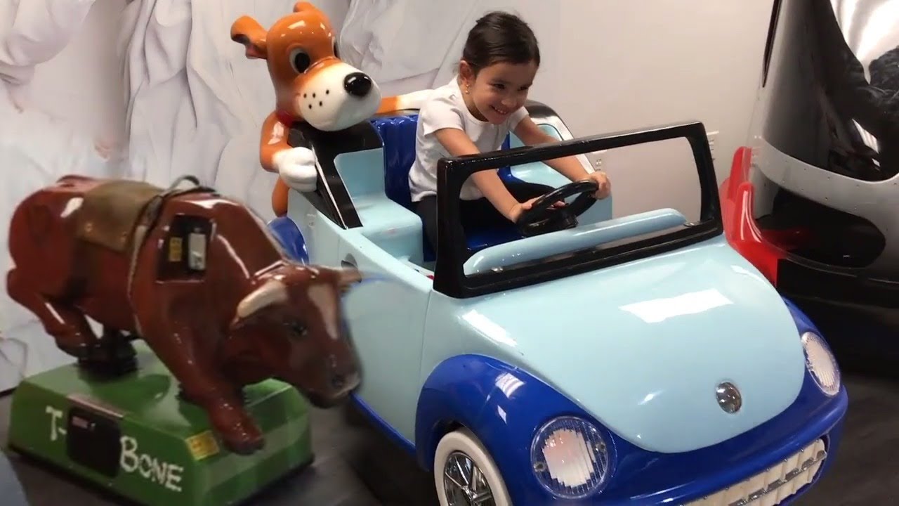 Cute Girl Riding Children's Cars at the Mall. Fun Kid Car Rides and ...