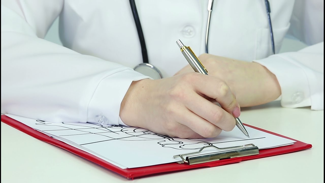 Medical student writing test during anatomy class, studying human ...