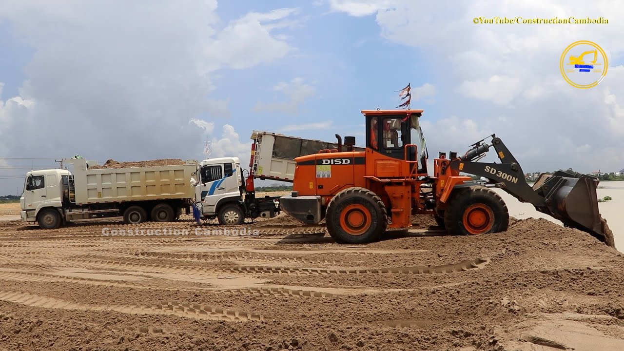 Dozer Wheel Loader Pushing Sand & Dump Trucks Unloading Sand Filling ...