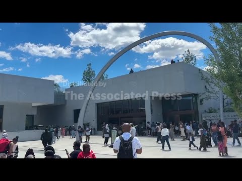 Barack and Michelle Obama surprise first visitors to newly opened presidential center
