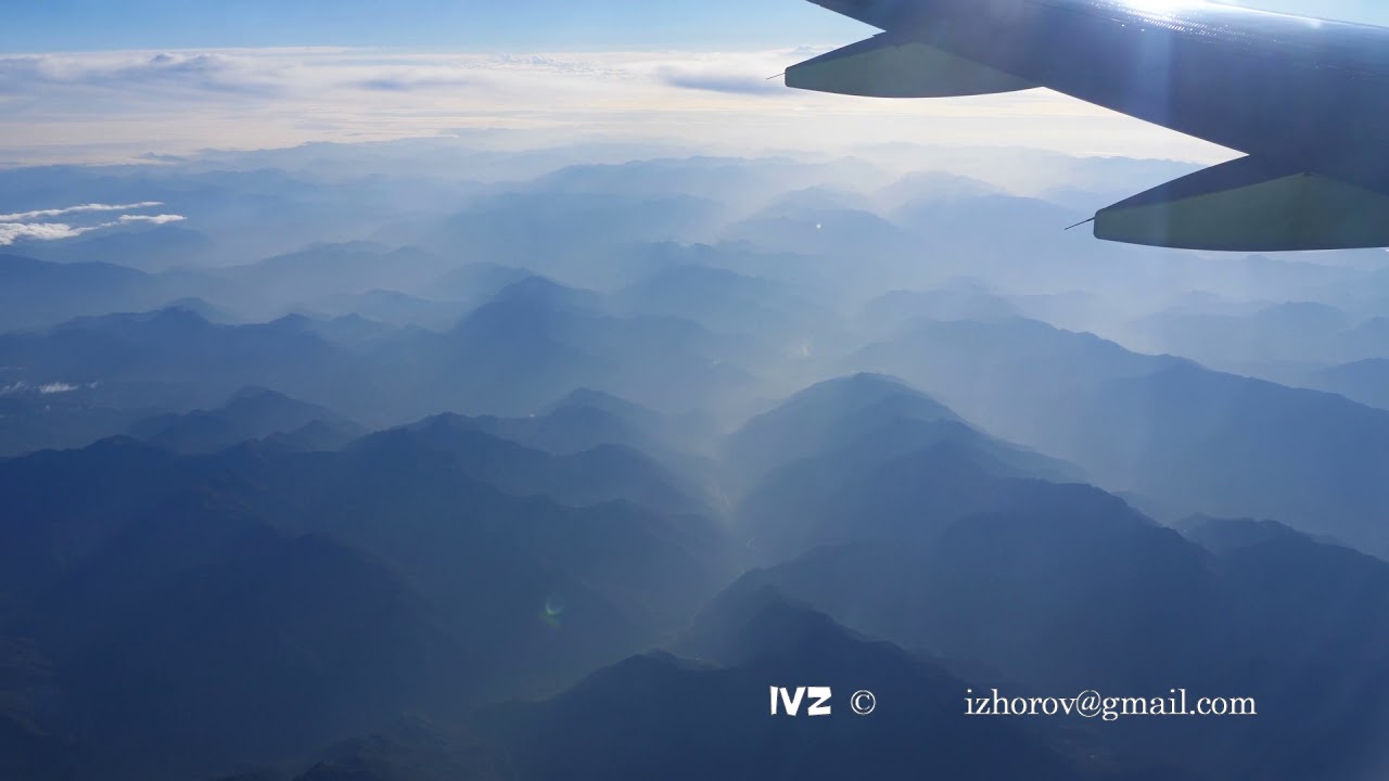 Beautiful view through airplane window, airplane flying above river in ...