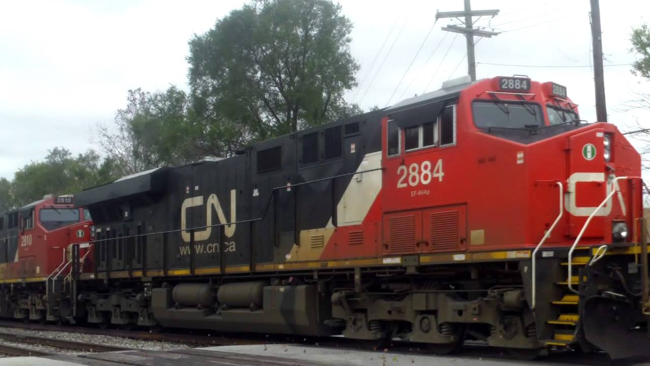 CN 3022 leads ES44AC duo, ex-BNSF, ex-UP engines, and B&LE SD38AC on ...