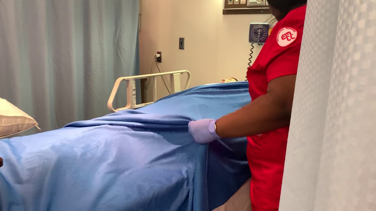 Changing linens on occupied bed - YouTube