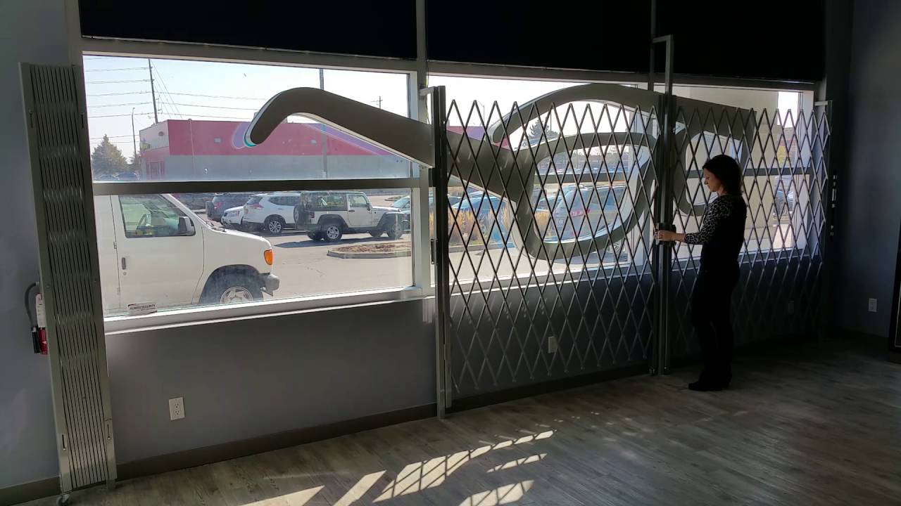 Locking up store front with security gates - YouTube
