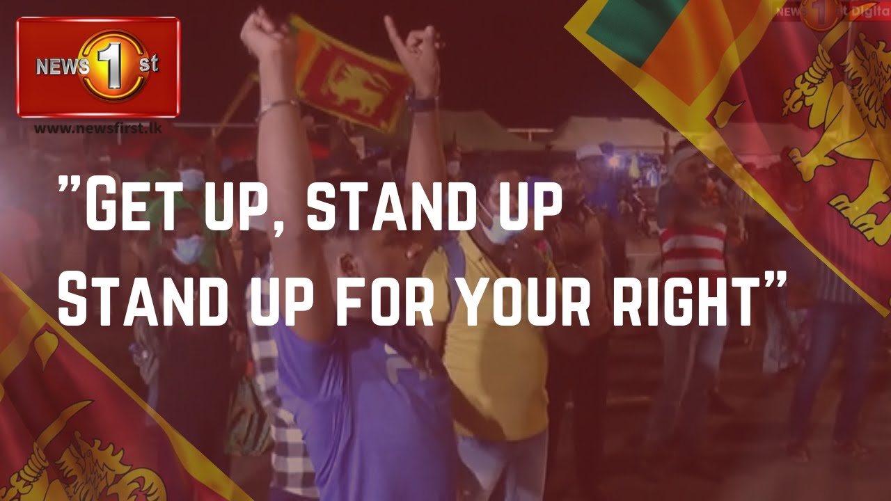 "Get up, stand up. Stand up for your right" protesters sing at ...