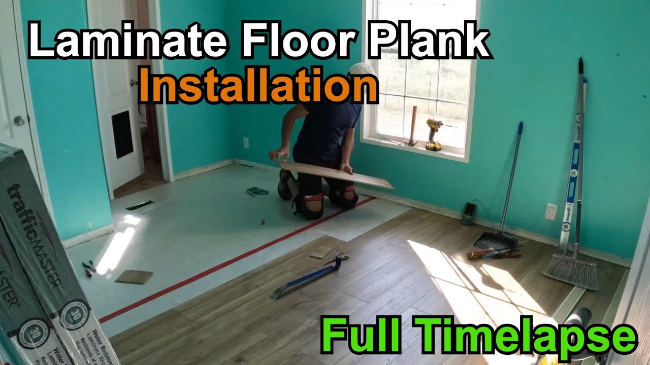 laying interlocking laminate floor planks and underlayment Timelapse ...