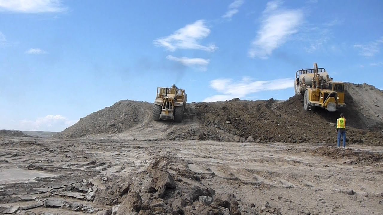 OM NOM NOM - Caterpillar 657 Scrapers Raping a Mountain Part 1 - YouTube