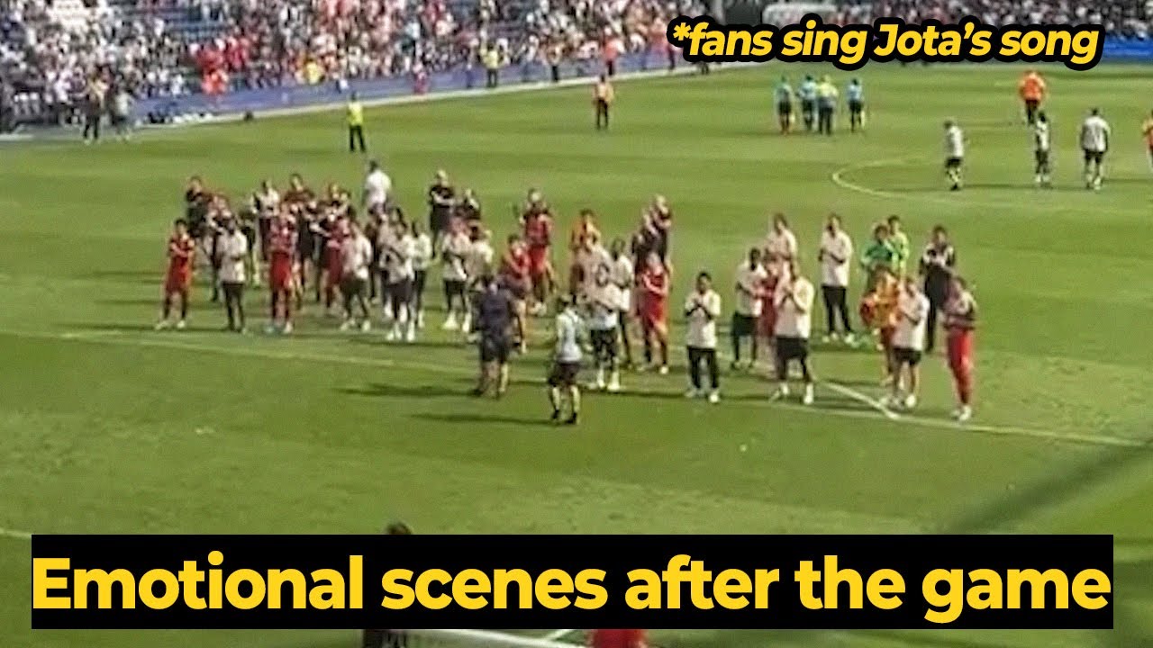 Liverpool players and staff stand and applaud as the Jota chant goes on ...