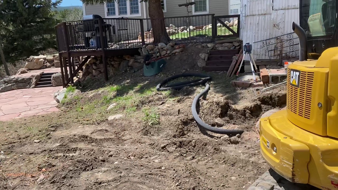 Boulder retaining wall installation with some instruction mixed in ...