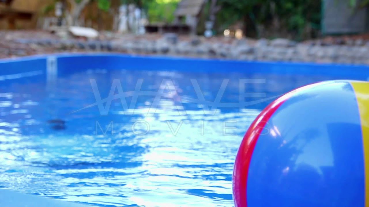Colorful beach ball hits another balls in the pool - YouTube