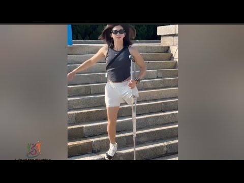 The beautiful amputee woman walks on one leg with one crutch # ...