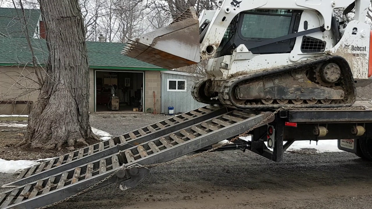 Bobcat Unloading Down Ramps - YouTube