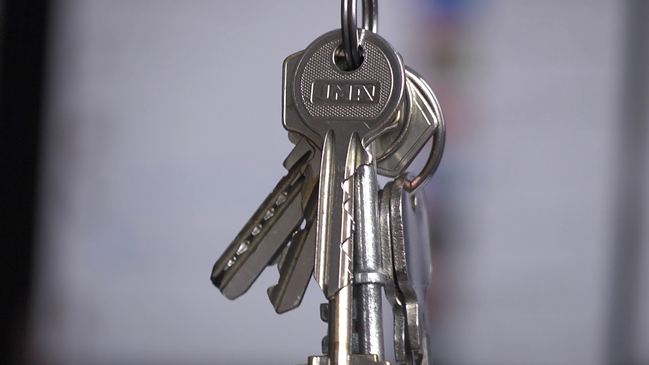 Janitor holds and wiggles key chains, rings and cases. Slow motion HD ...